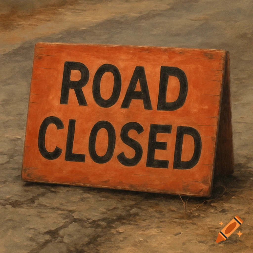 An orange A-frame sign sits on the ground, reading "ROAD CLOSED" in ...
